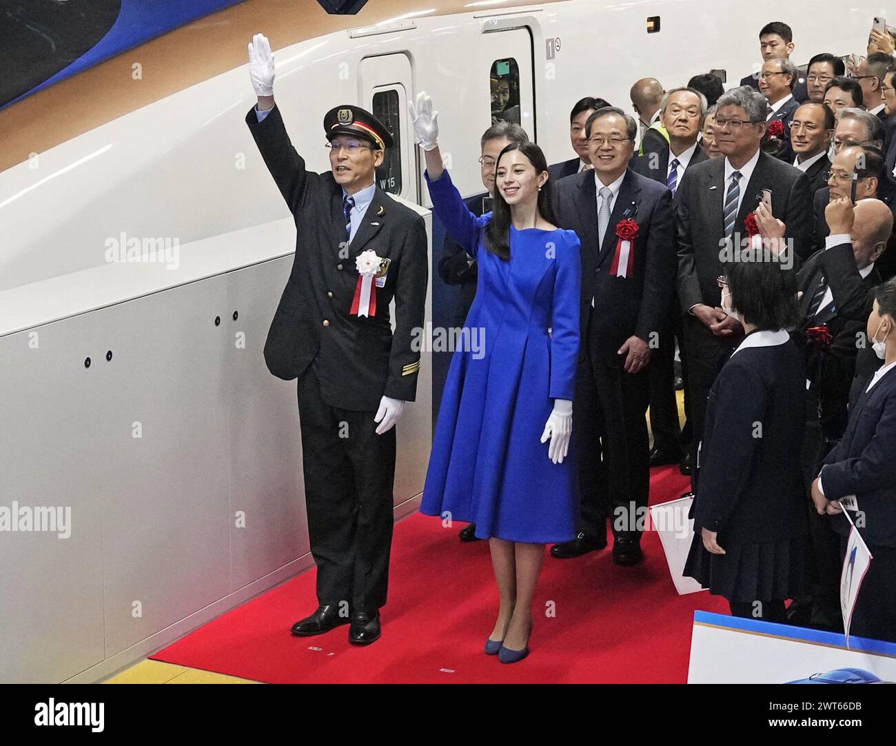 Actress Ayami Nakajo (2nd from L) gestures prior to the departure of the first train bound for ...