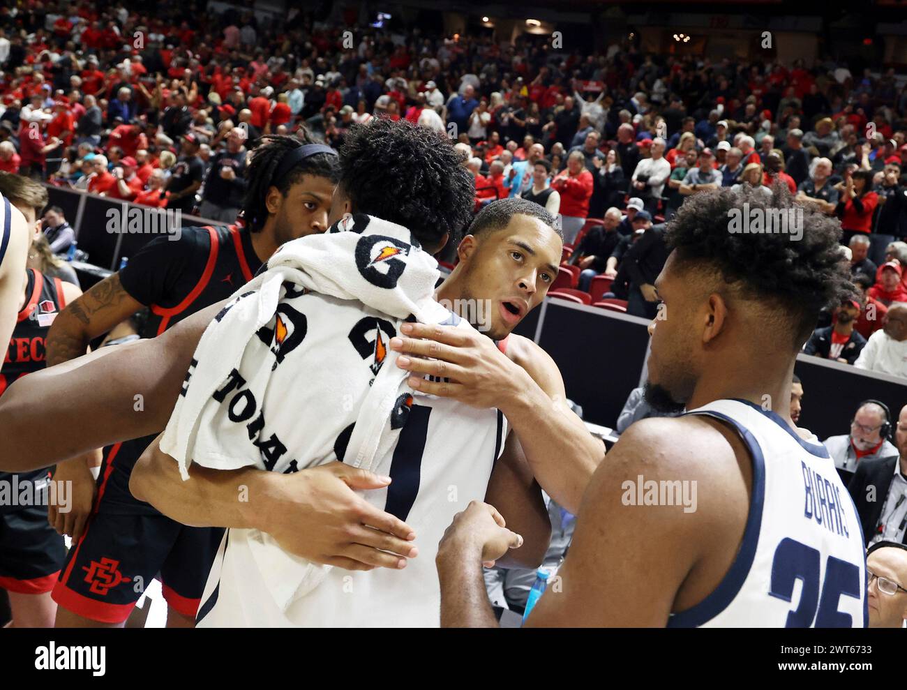 San Diego State forward Jaedon LeDee, center rear, embraces Utah State ...