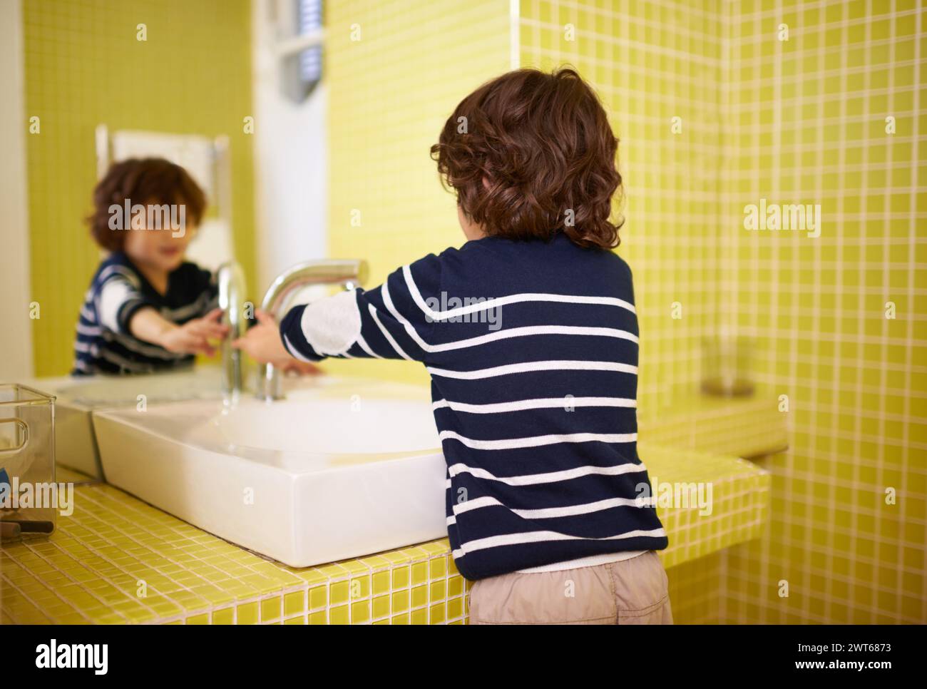 Boy, bathroom and hands with washing, hygiene and cleaning with mirror ...