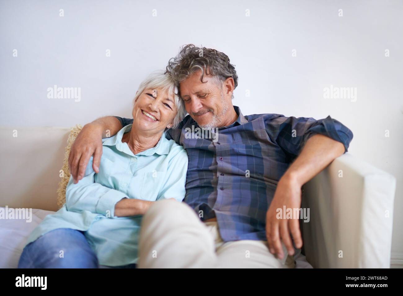 Old couple, hug and relax on sofa with happiness at home, love and ...
