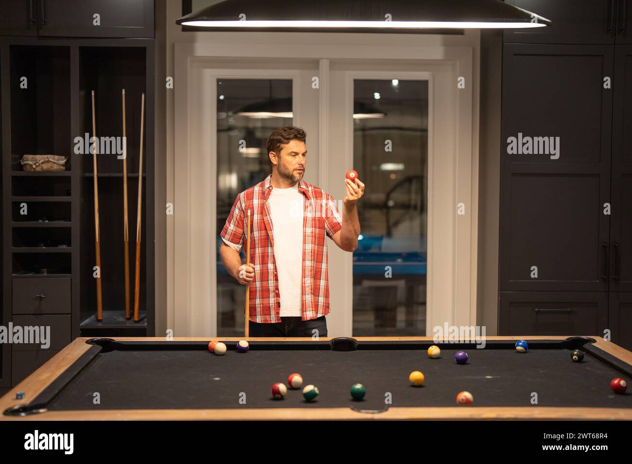 Man Playing the billiards. Man play american billiard in Billiard room ...
