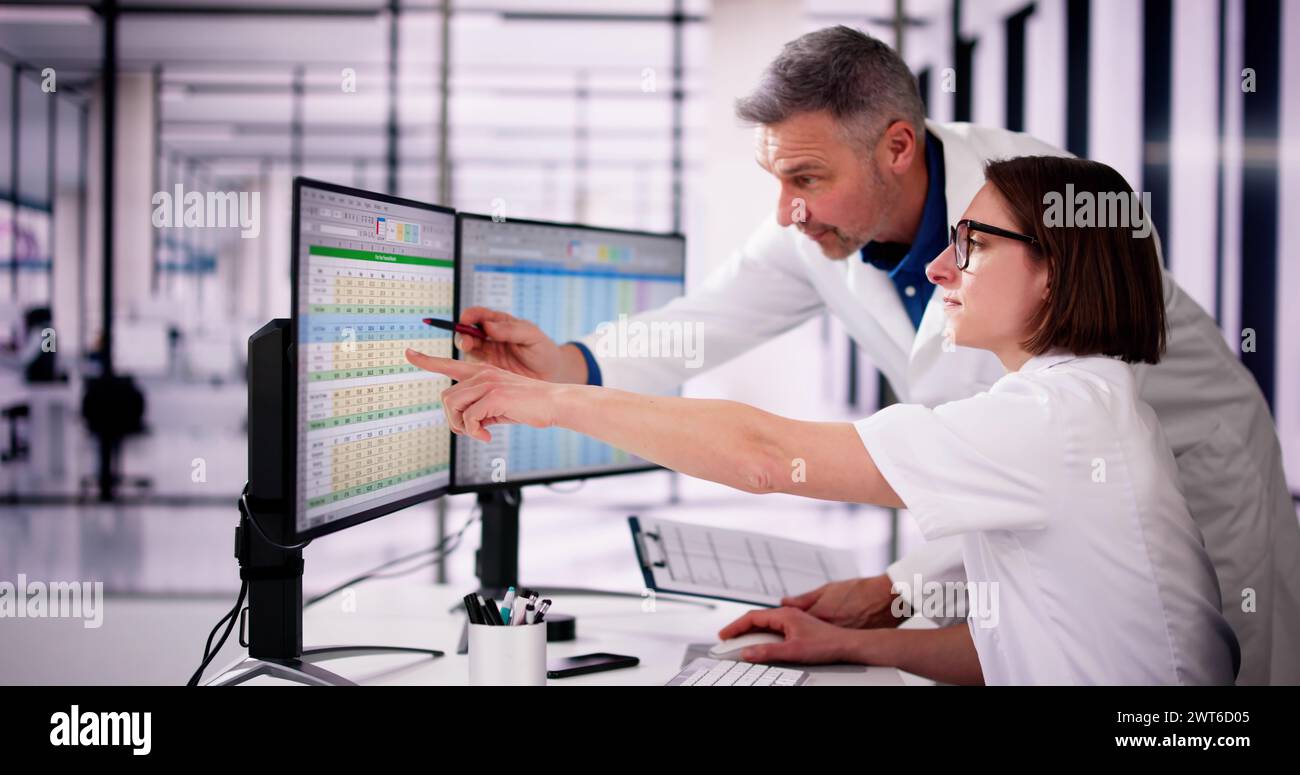 Hospital Doctor Using Spreadsheet For Billing Codes On Desktop Stock ...