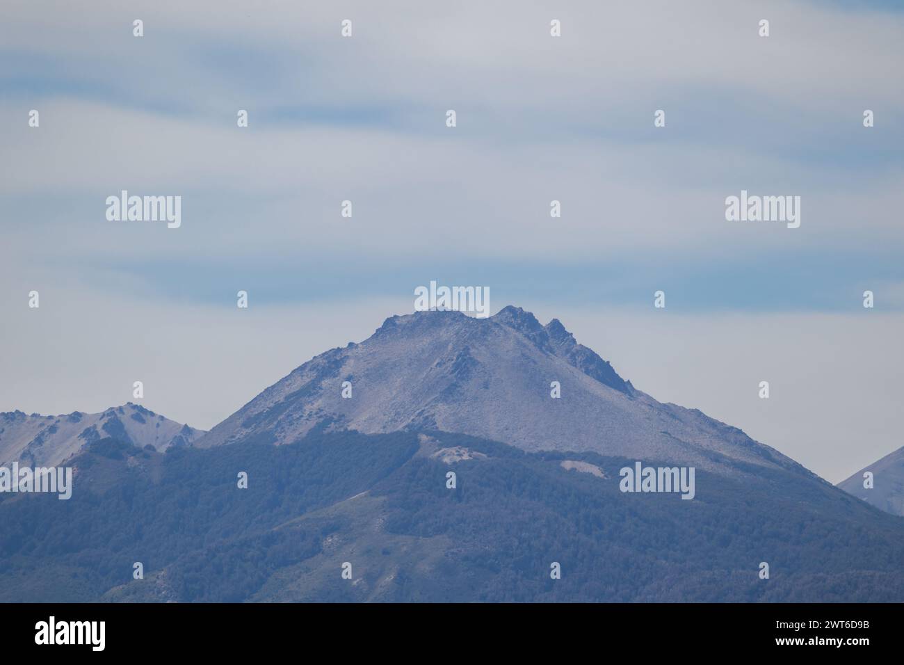 Lonely horizontal view of mountain peak with growing vegetation on the ...