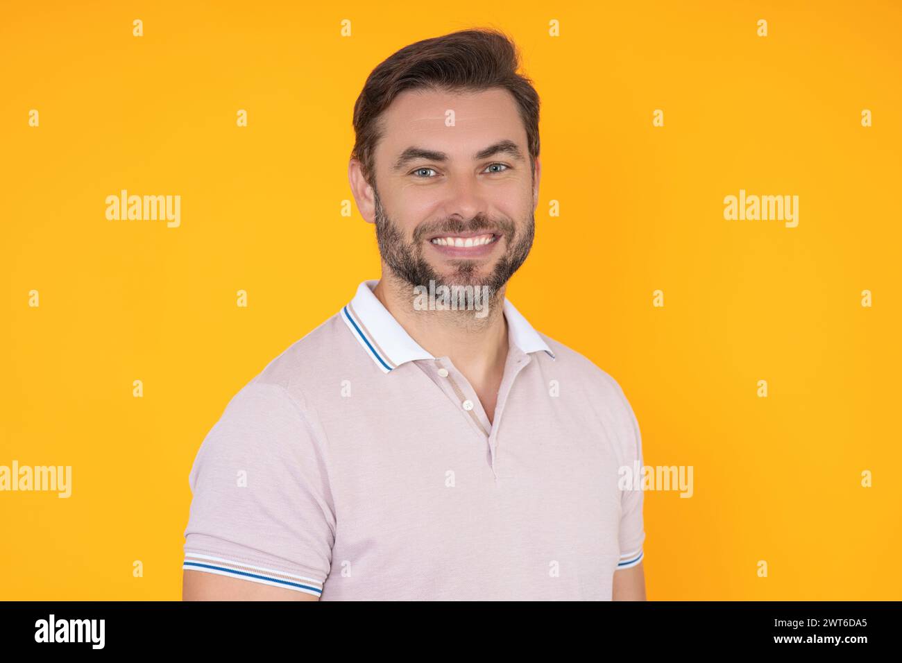 Smiling male model isolated on yellow. Positive man in good mood ...