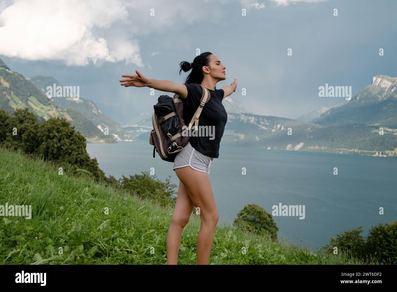 Calm woman dream in nature raised hands. Woman relaxing in alps ...