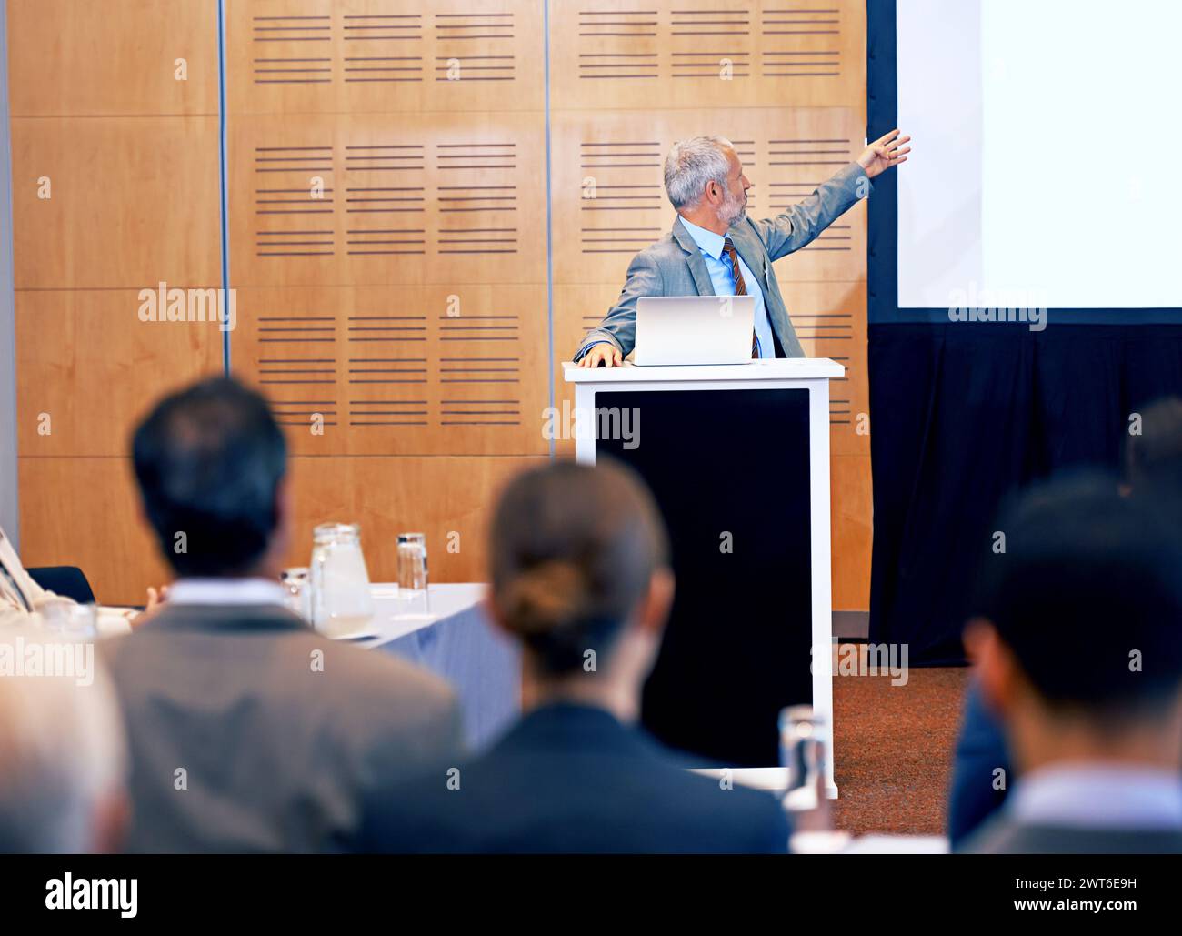Senior, businessman and presentation with laptop on projector for ...