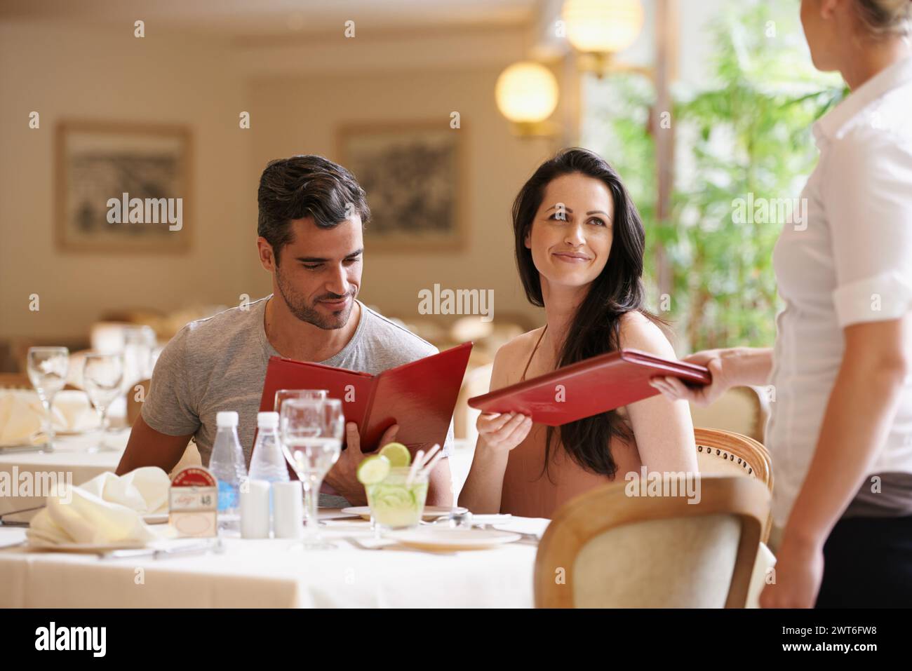 Couple, restaurant and menu with choice, lunch and love for anniversary ...