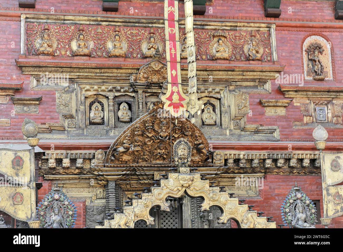 Elaborate wood carvings and reliefs on the facade of a temple ...