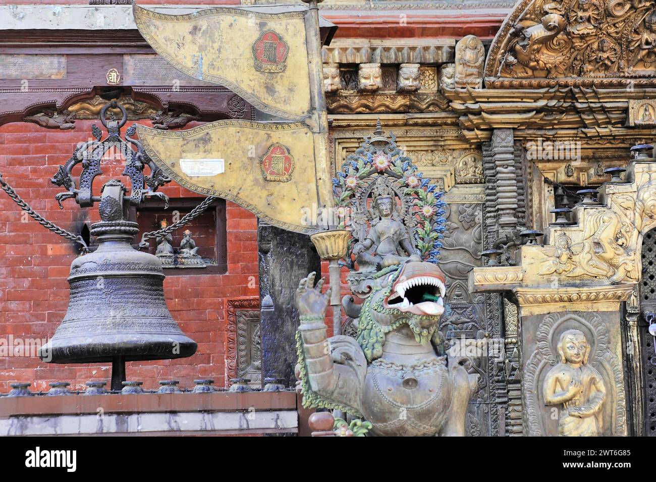 Old bell and dragon figure in front of artistically carved wooden ...