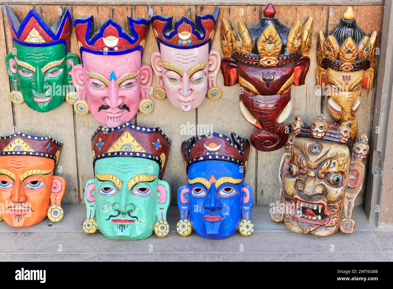 Wall with a selection of colourful traditional masks in a handicraft ...