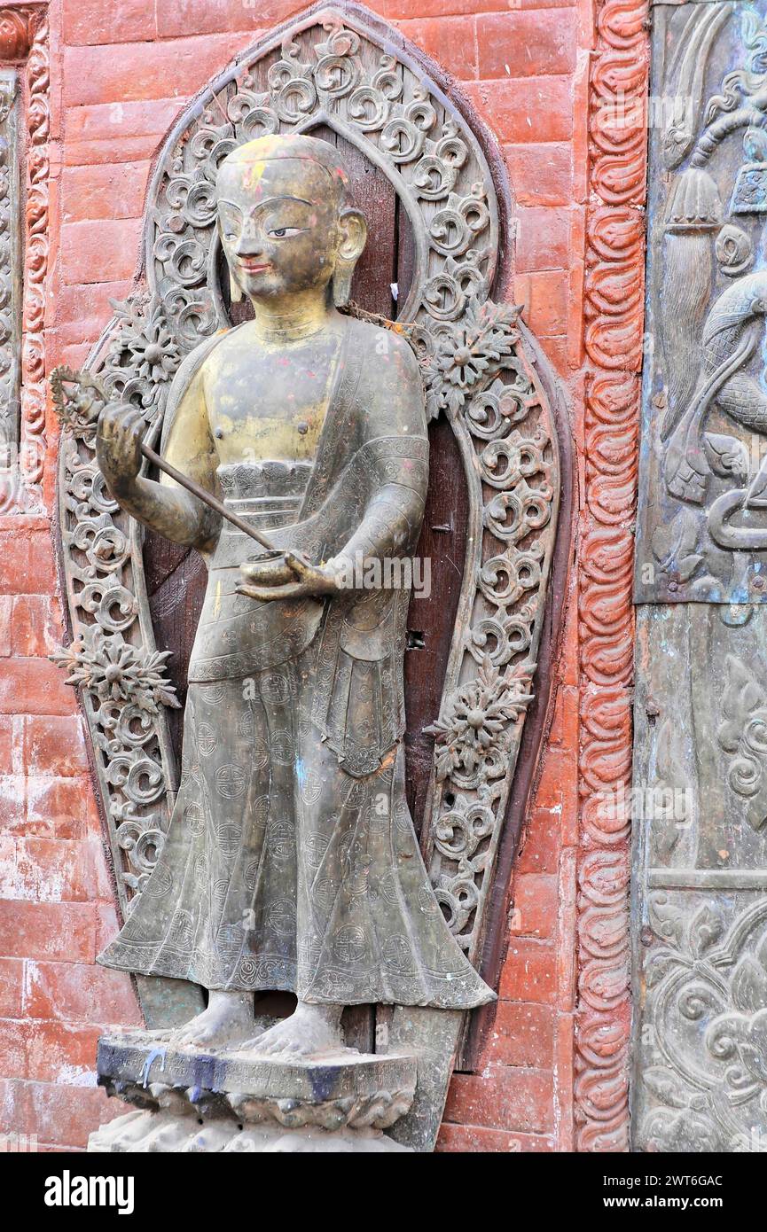 Ancient stone sculpture of a standing religious figure with patina on a ...