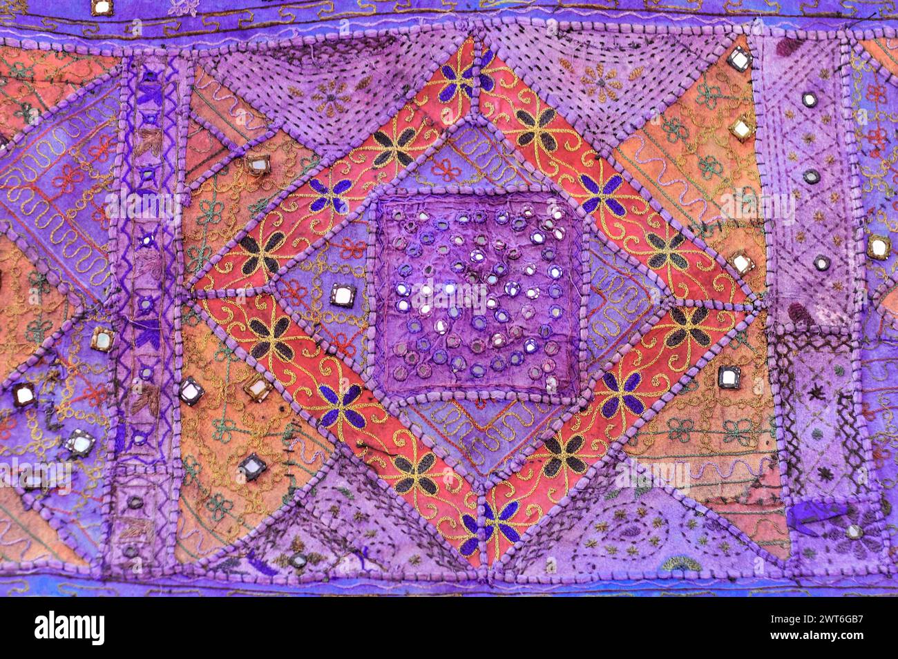 Geometric fabric design with purple colour tones and symmetrical ...