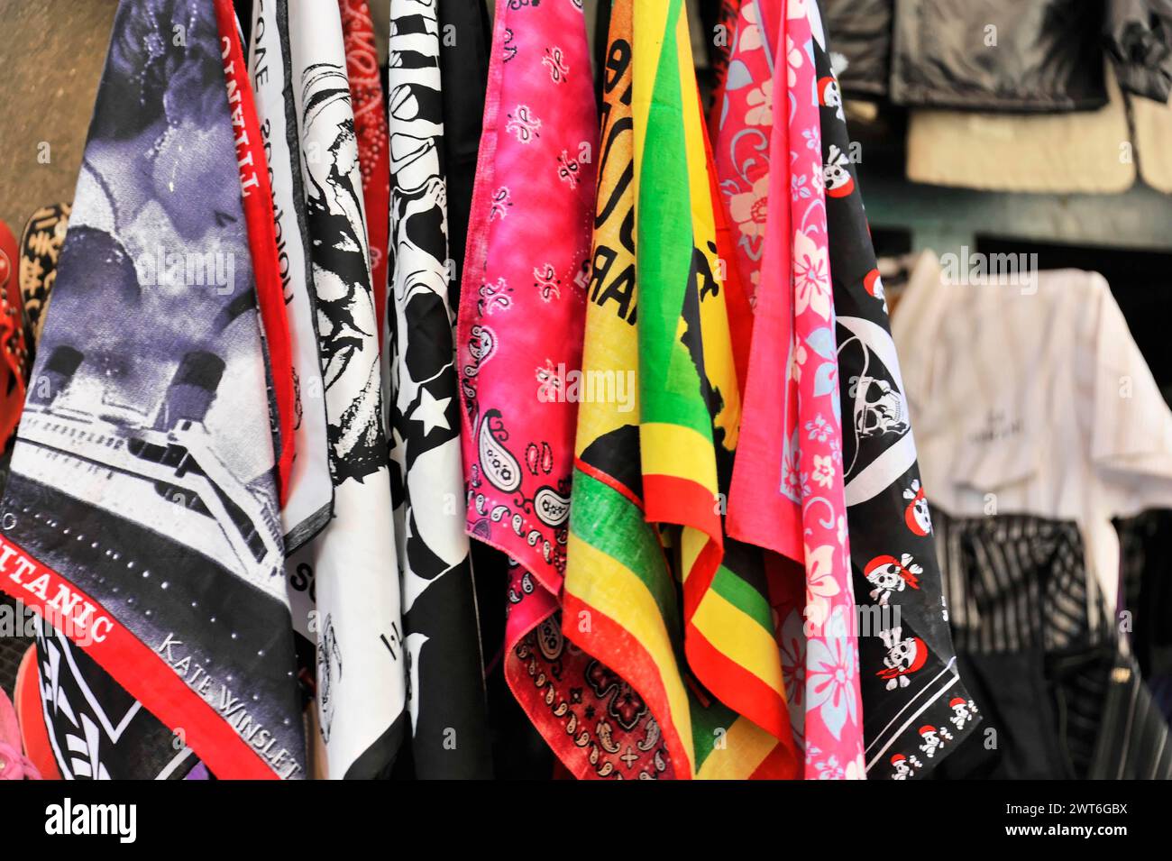 Colourfully patterned cloths with various prints hang in a stall ...