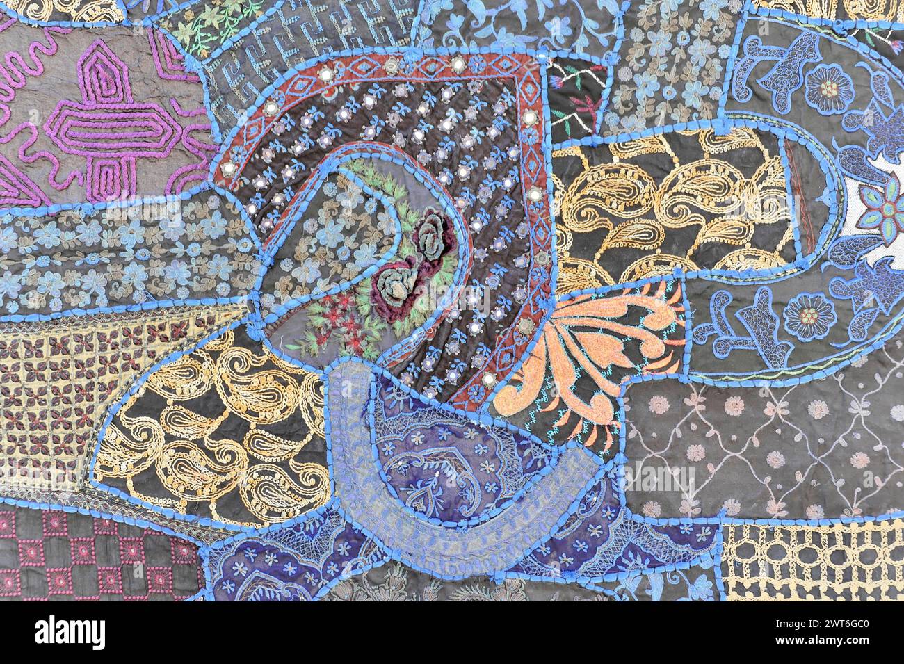 Varied patchwork of different fabric patterns with embroidery and ...