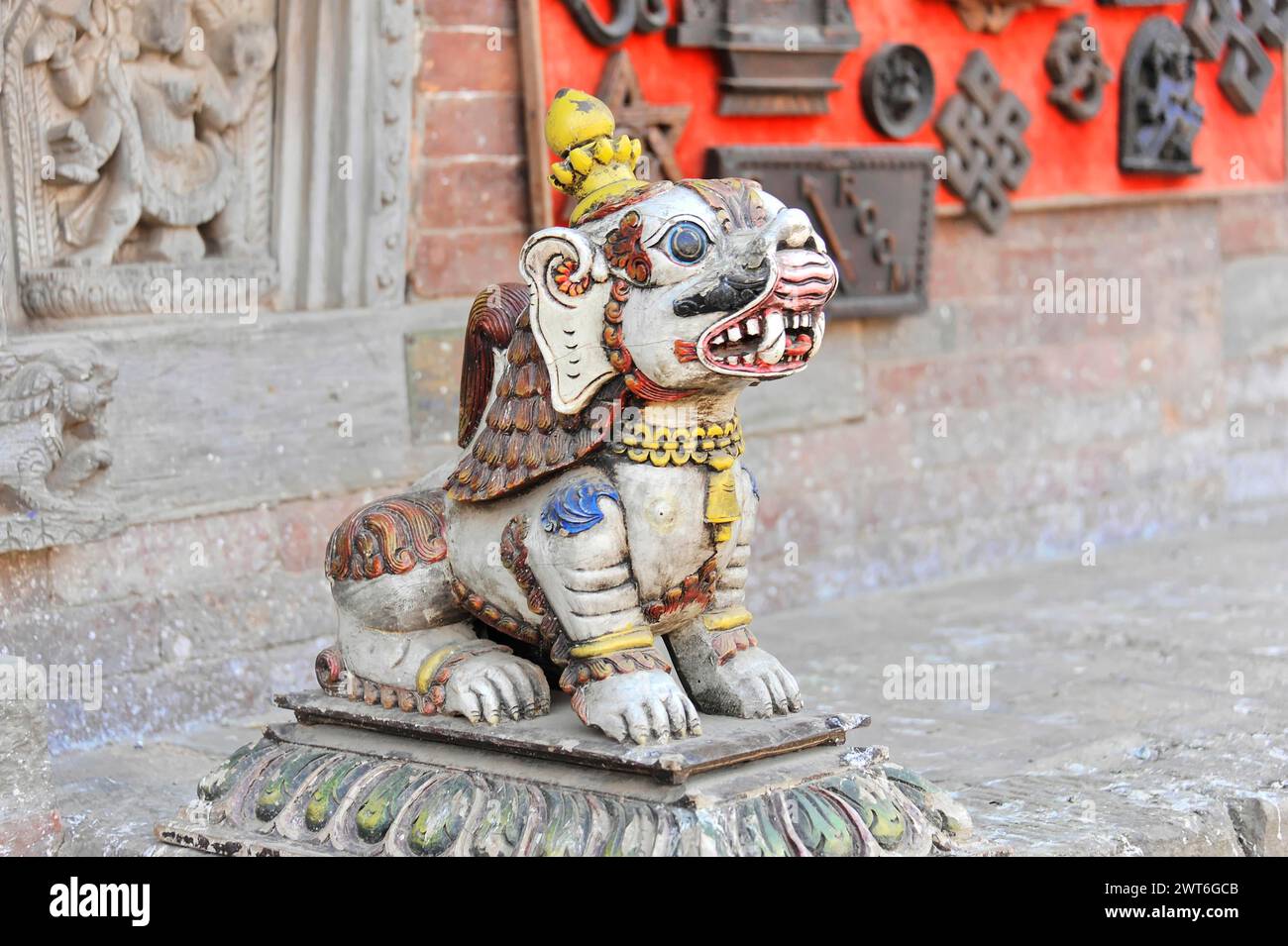 Colourful painted statue of a temple guardian in the shape of a lion ...