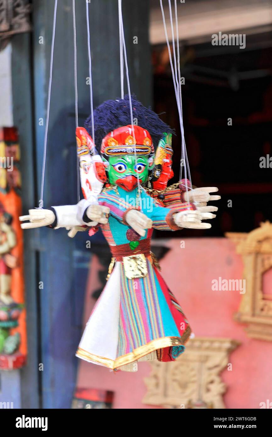 A colourful puppet in traditional dress hangs on strings, Kathmandu ...