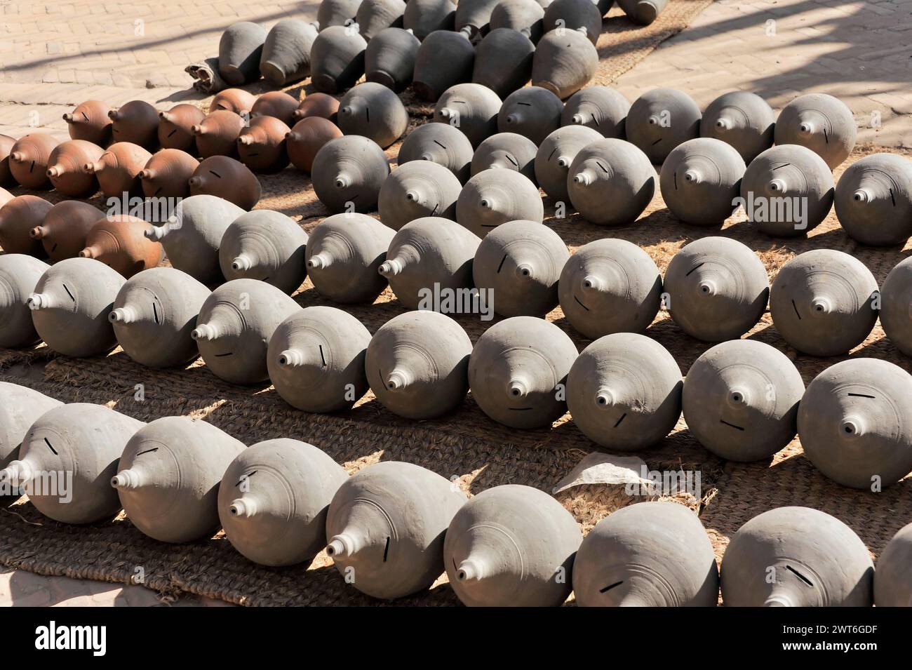 Row of handmade clay pots displayed on the ground for sale, Kathmandu ...