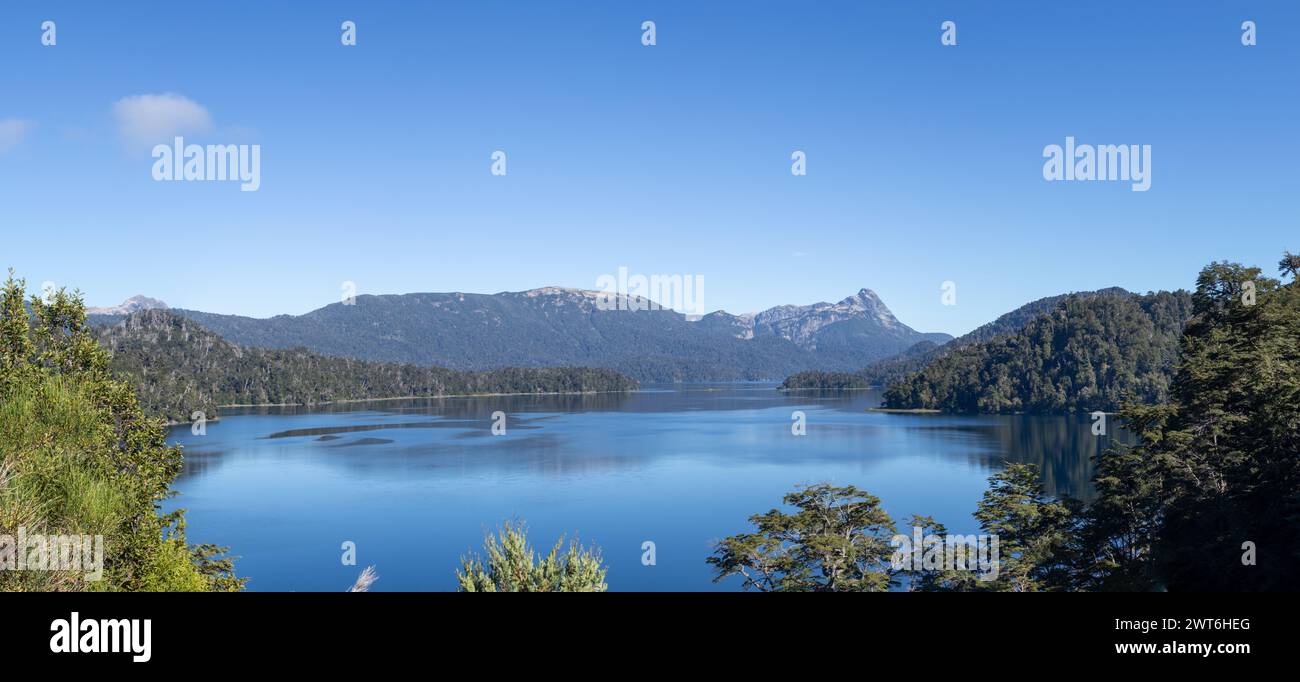 Majestic nature view of a huge clear blue lake reflecting the forest ...