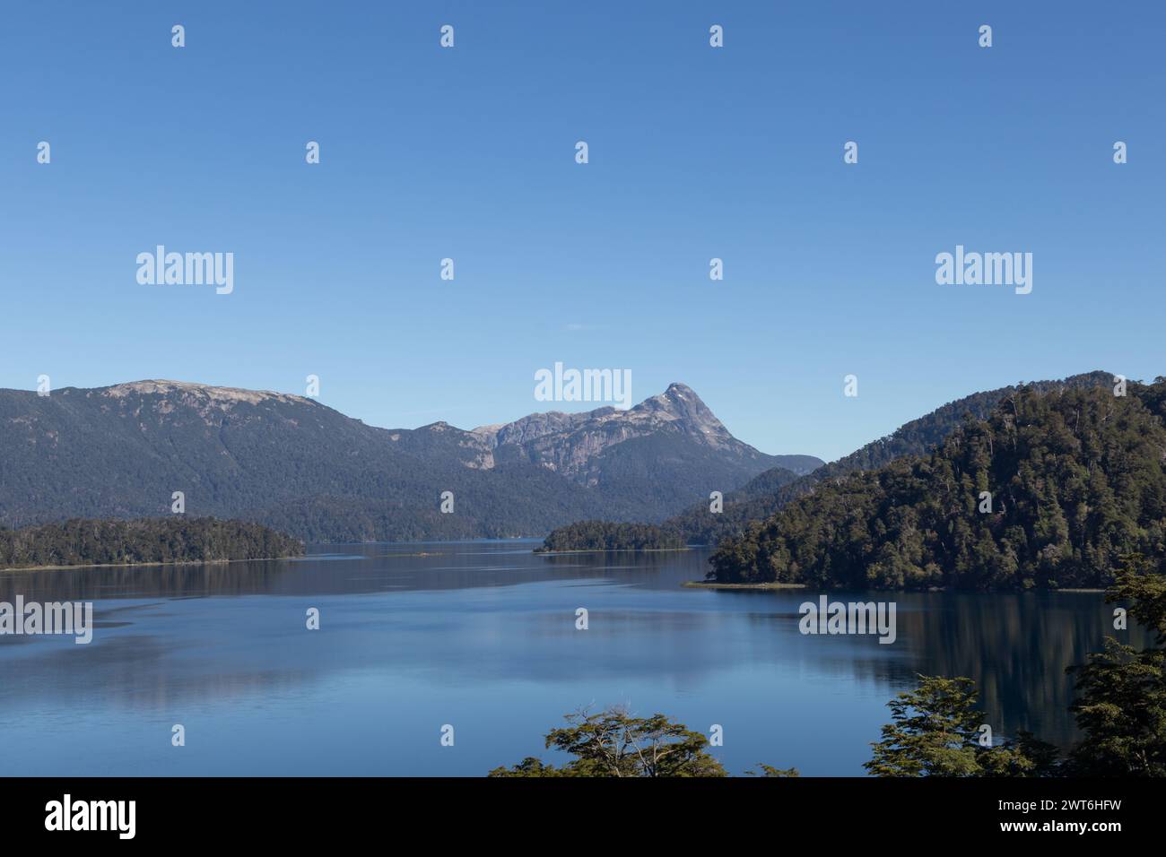 Majestic nature view of a huge clear blue lake reflecting the forest ...