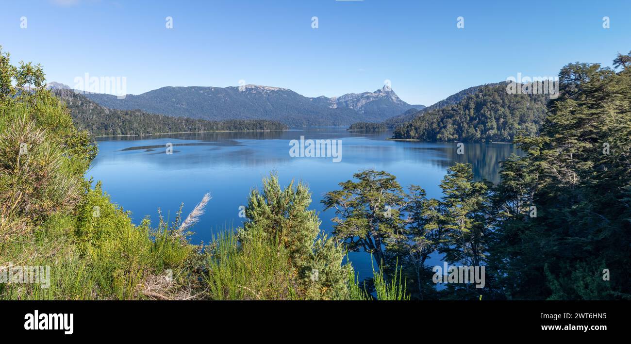 Majestic nature view of a huge clear blue lake reflecting the forest ...