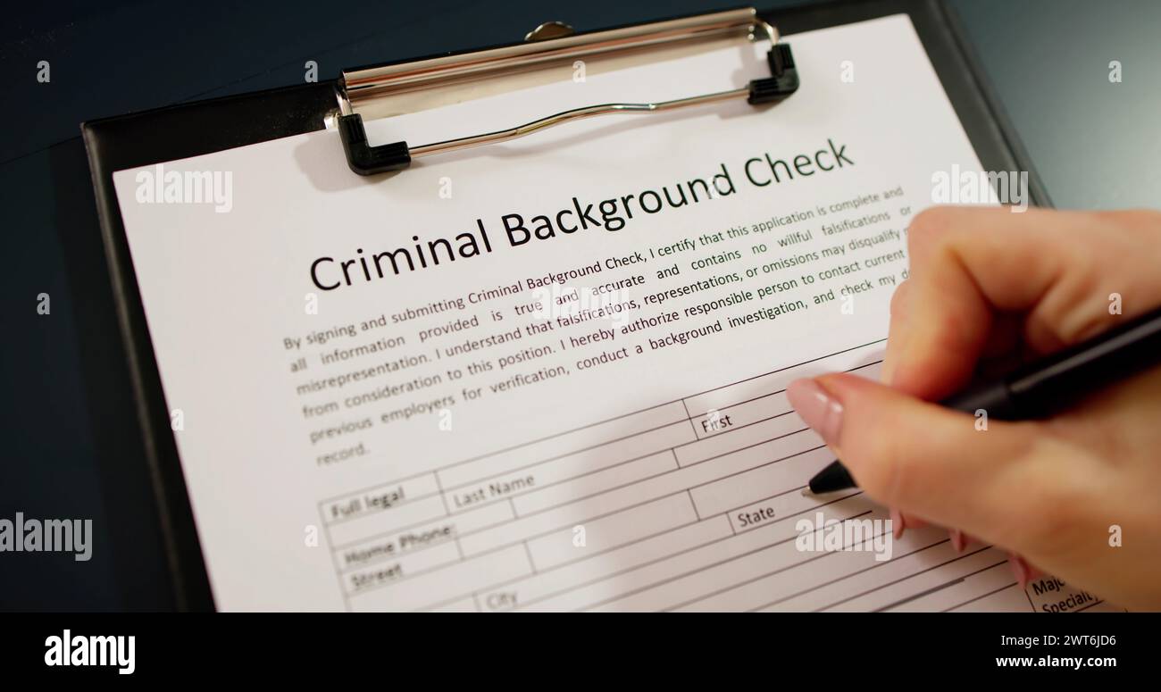 Hand Filling Criminal Background Check Application Form Stock Photo - Alamy