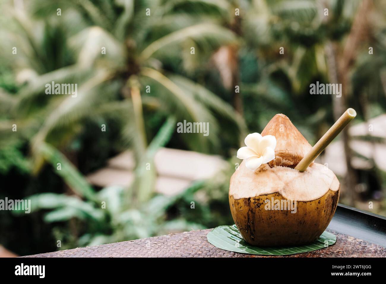 an opened coconut fruit, ready to enjoy, served on a resort Stock Photo ...