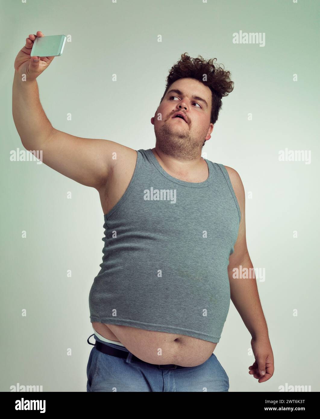 Selfie, fashion and plus size man in studio posing with casual, trendy ...