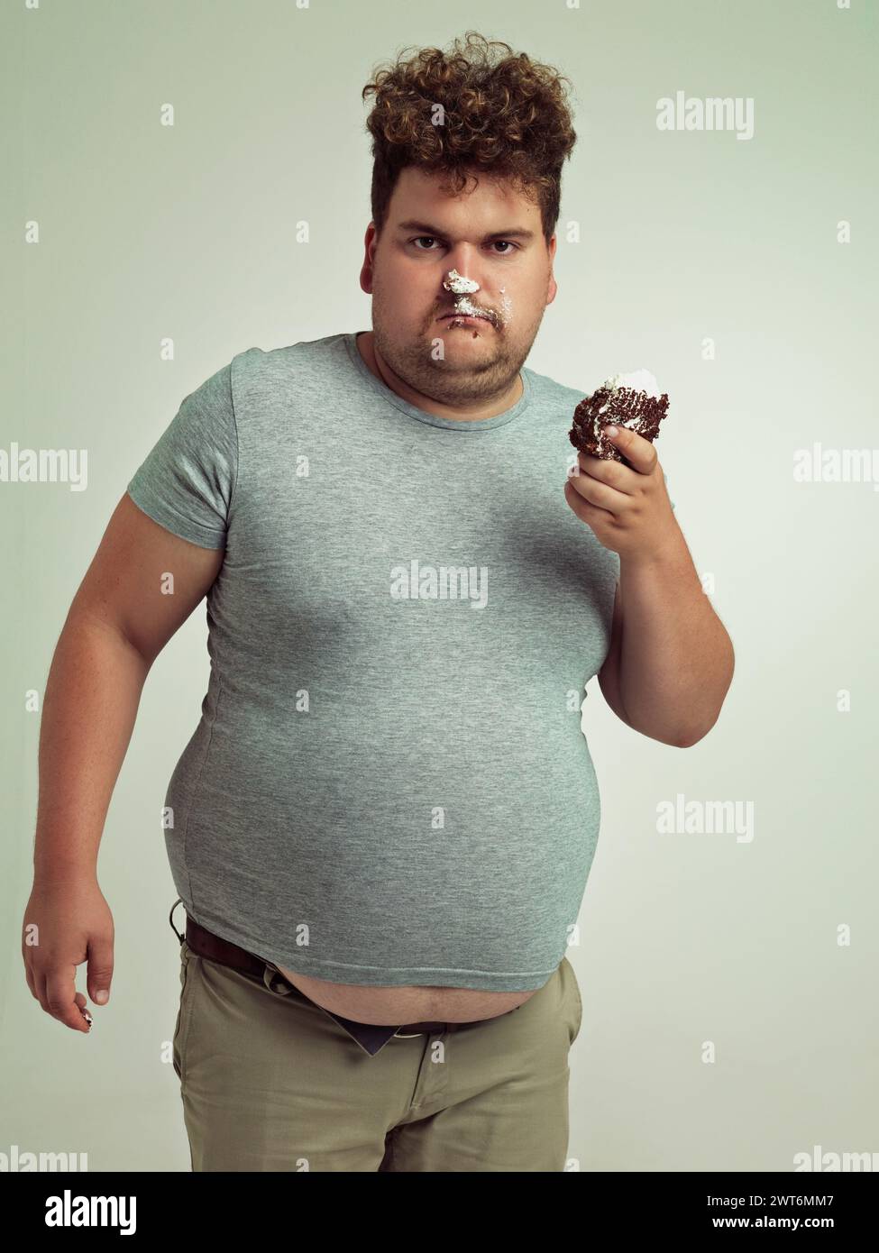 Chocolate cake, portrait and plus size man with grumpy, dessert and ...