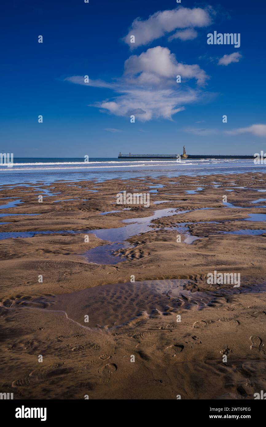 The vast sandy beach of Whitby West Cliff. In the distance is the west ...