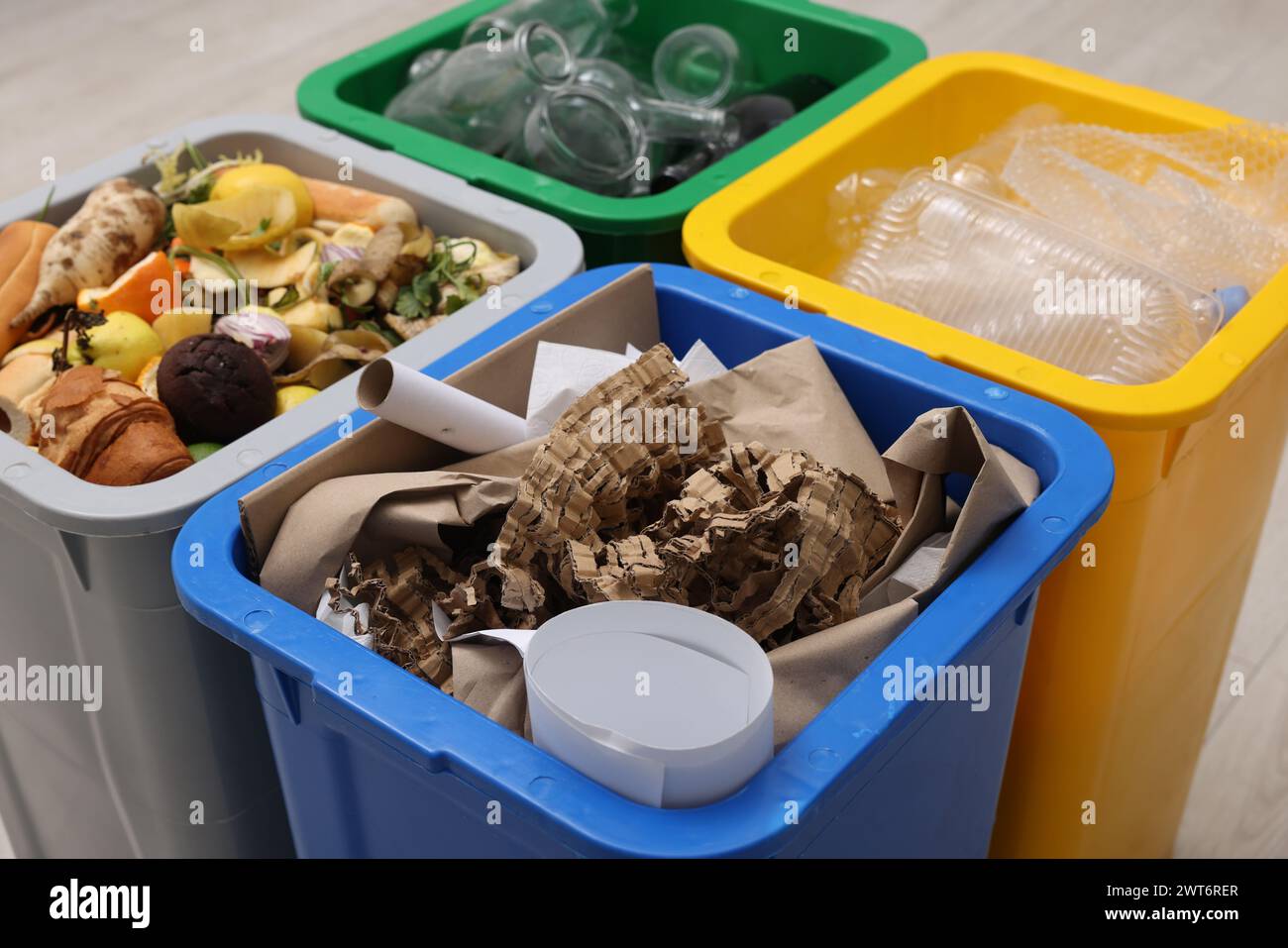 Garbage sorting. Full trash bins for separate waste collection indoors ...