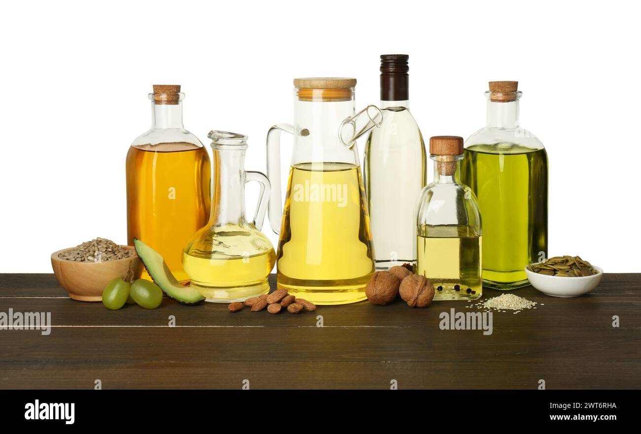 Vegetable fats. Different cooking oils and ingredients on wooden table ...