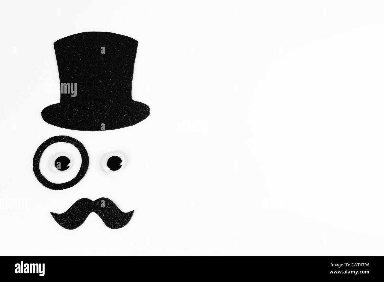 Man's face made of fake mustache, hat, eyes and monocle on white ...