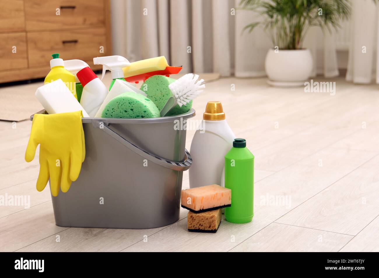 Different cleaning supplies in bucket on floor Stock Photo - Alamy