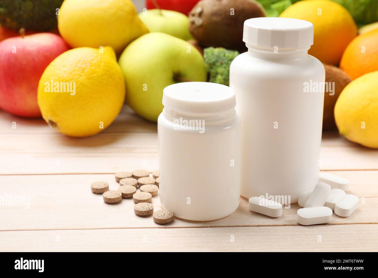 Dietary supplements. Blank white bottles and different pills near food ...