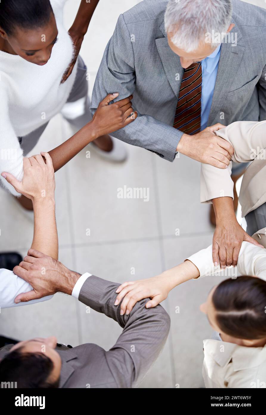 Business people, top view and arm circle in office in support for teamwork, collaboration or ...
