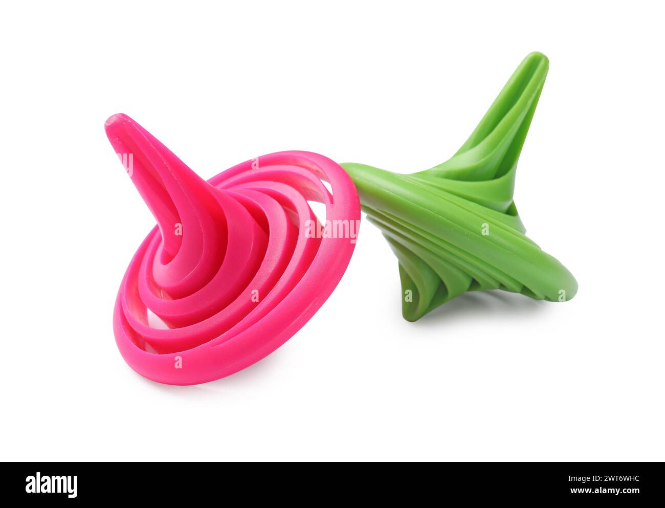 Green and pink spinning tops isolated on white Stock Photo - Alamy