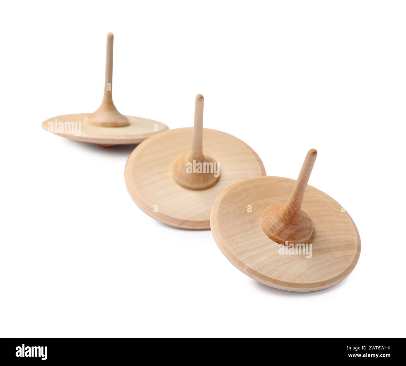 Many wooden spinning tops isolated on white Stock Photo - Alamy