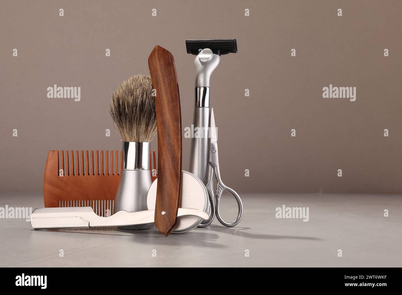 Moustache and beard styling tools on grey table. Space for text Stock ...