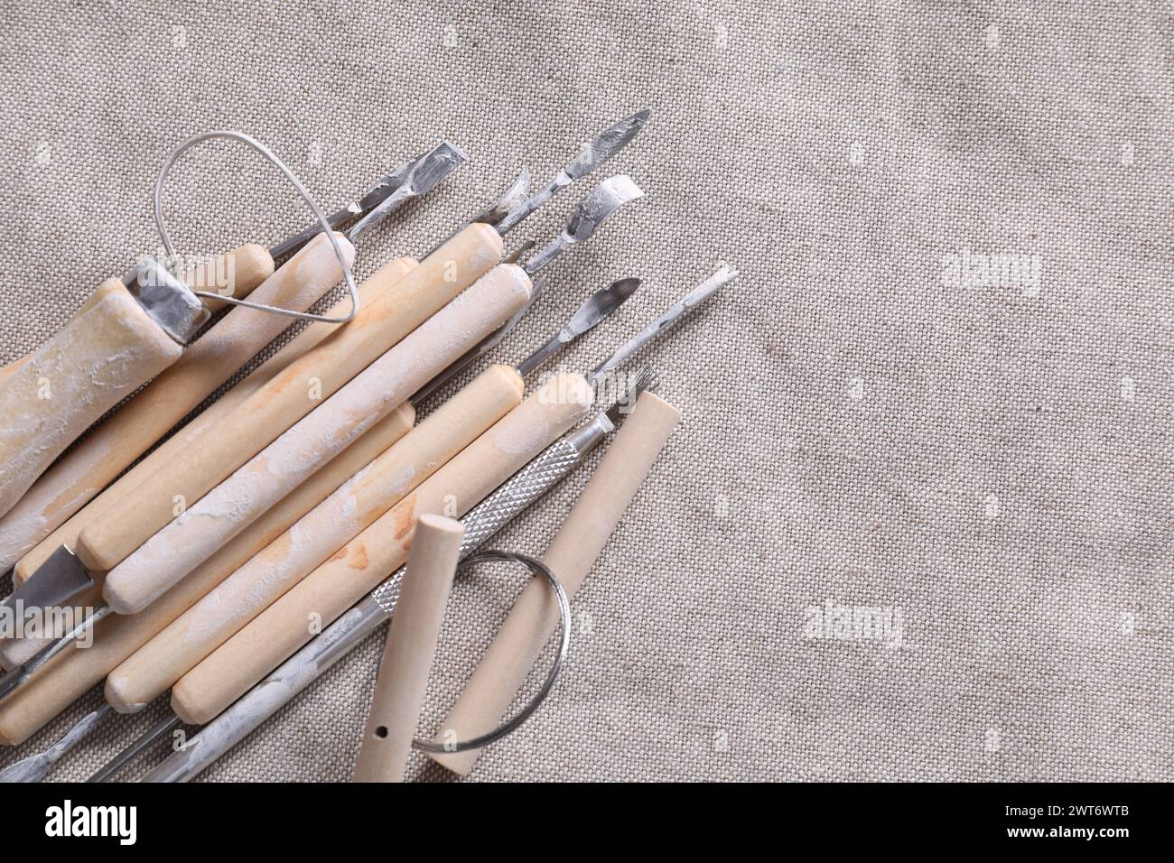 Set of different clay crafting tools on grey fabric, top view. Space ...