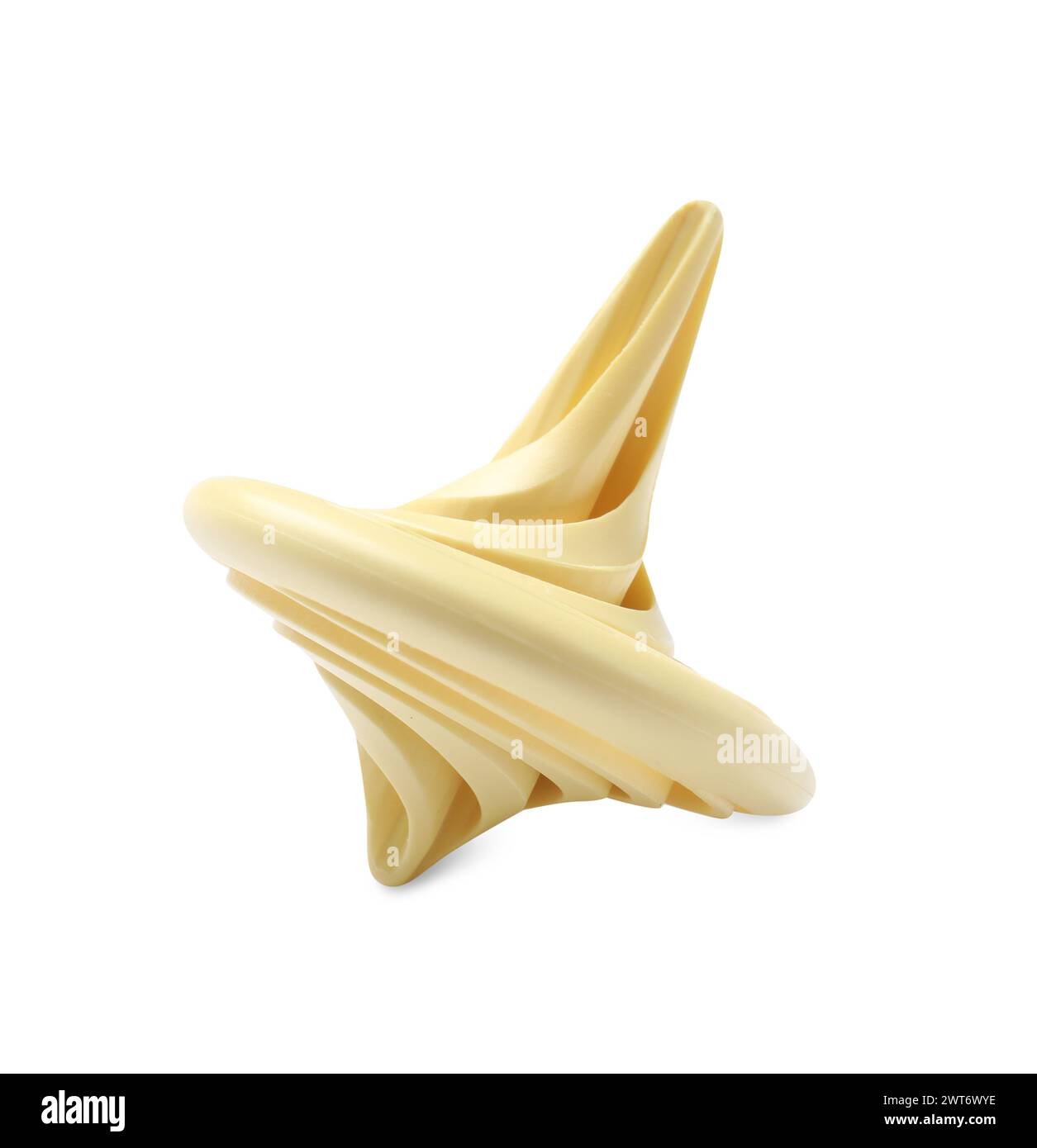 One pale yellow spinning top on white background Stock Photo - Alamy