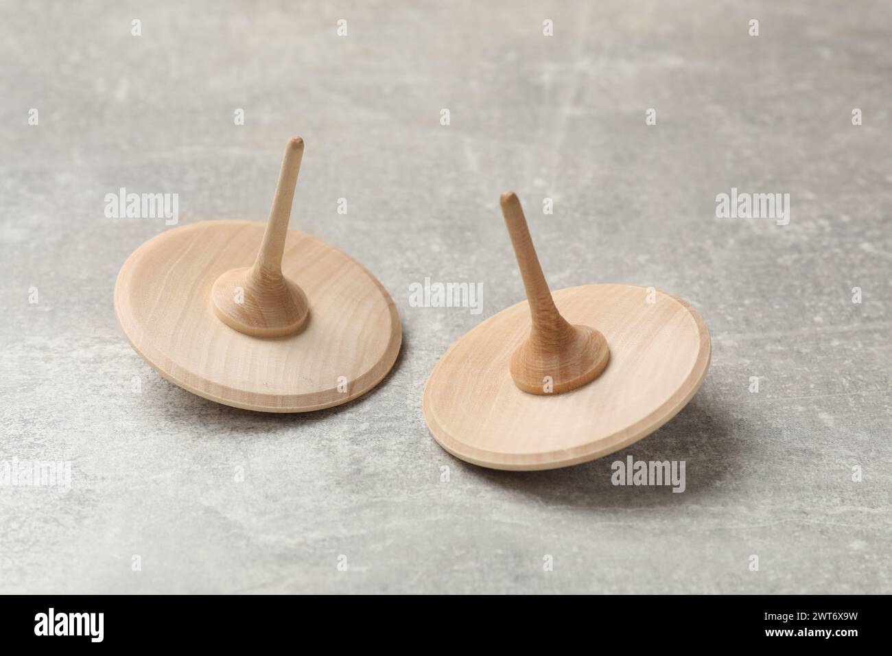 Wooden spinning tops on grey textured background, closeup Stock Photo ...