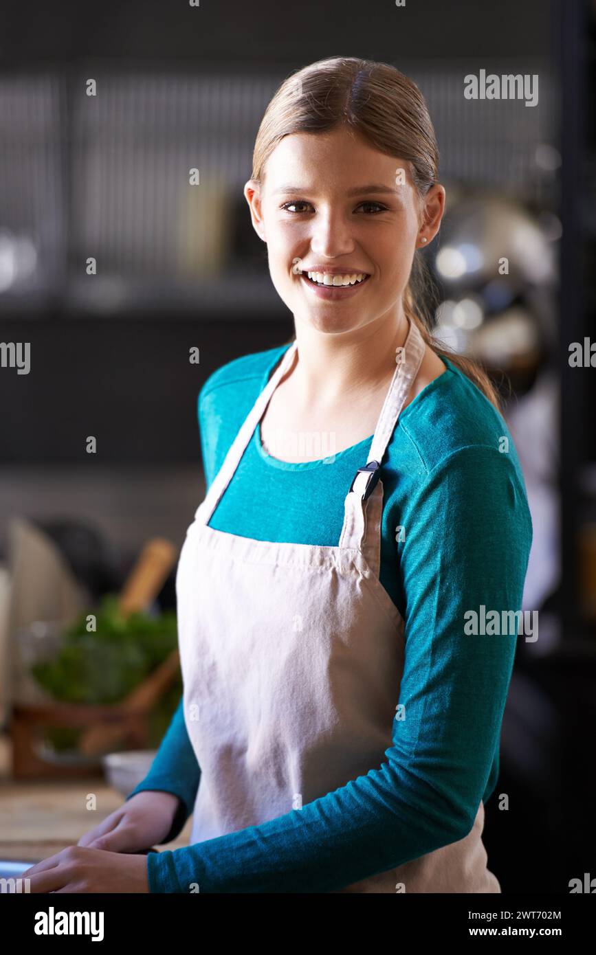 Portrait, cooking and woman with ingredients in kitchen cutting food ...