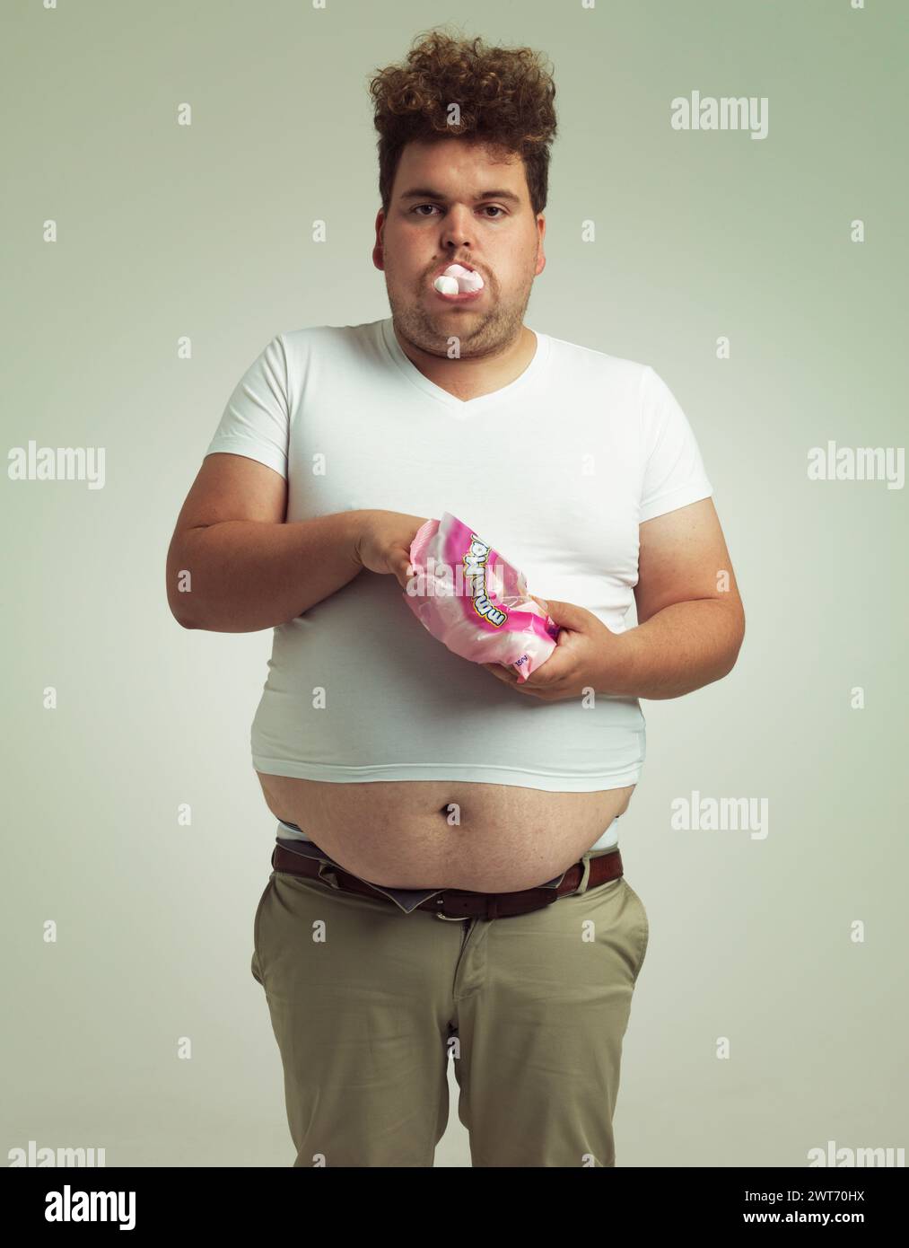 Food, portrait and plus size man with marshmallow, dessert and candy in ...