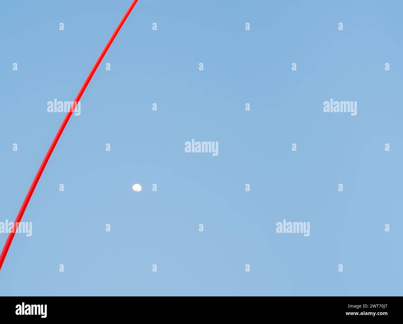 Red stripe divides blue sky with small white moon in abstract ...