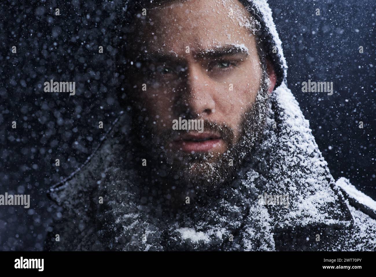Snow, night and man with serious portrait outdoor in winter with storm ...