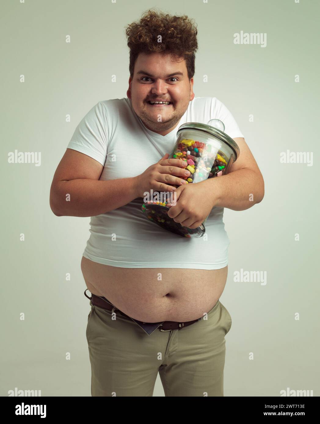 Candy, crazy and portrait of plus size man on white background for ...
