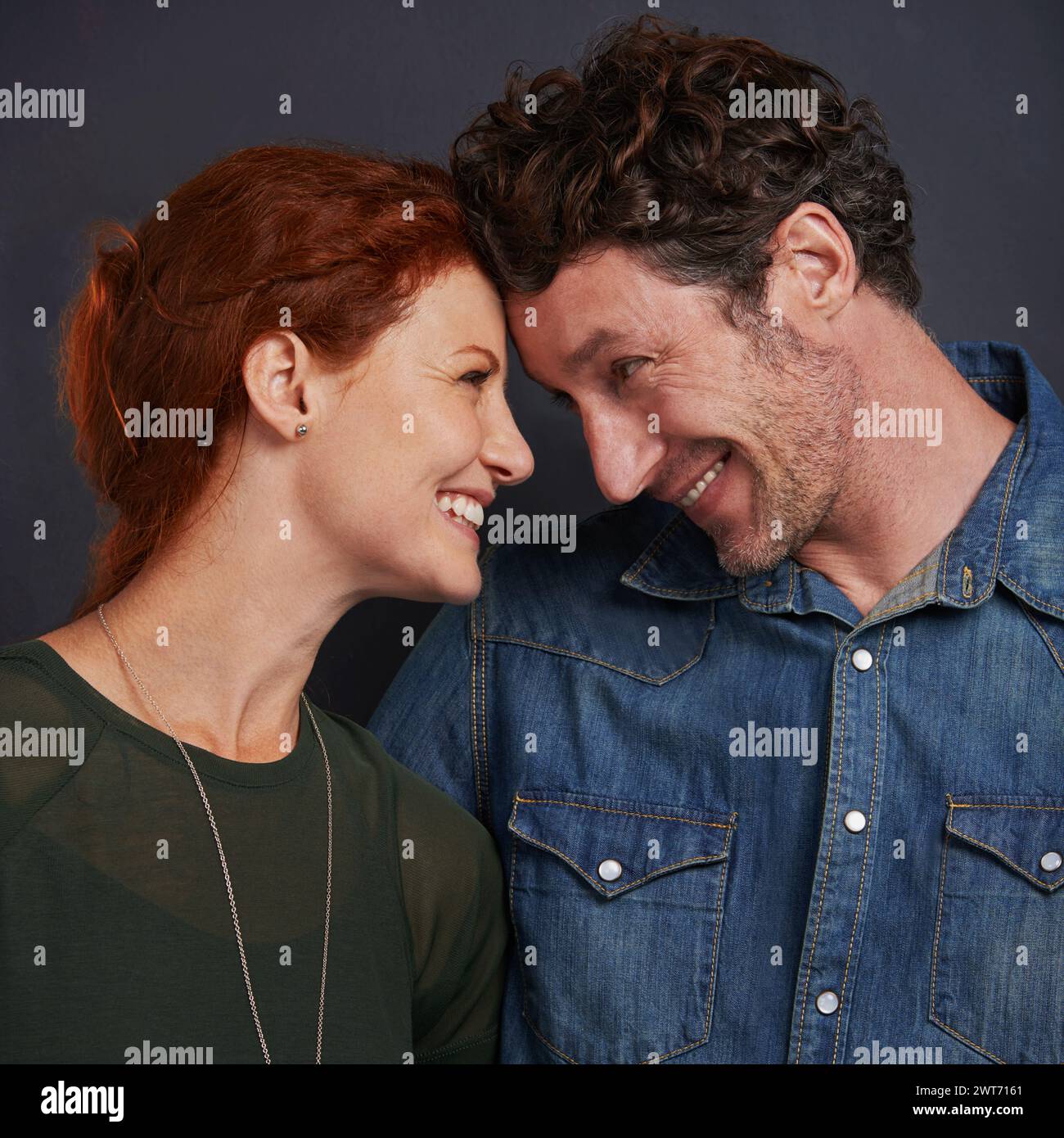 Love, smile and couple in studio together with happy relationship ...