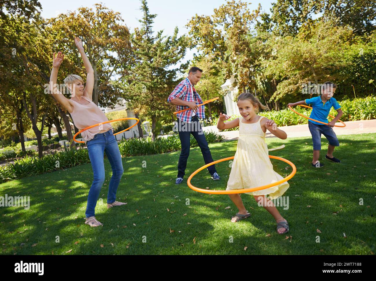 Parents, kids and hula hoop in park for playing, child development and ...