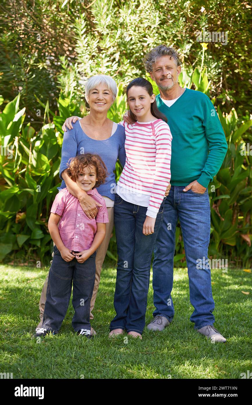 Grandparents, portrait and hug in outdoors, children and bonding ...