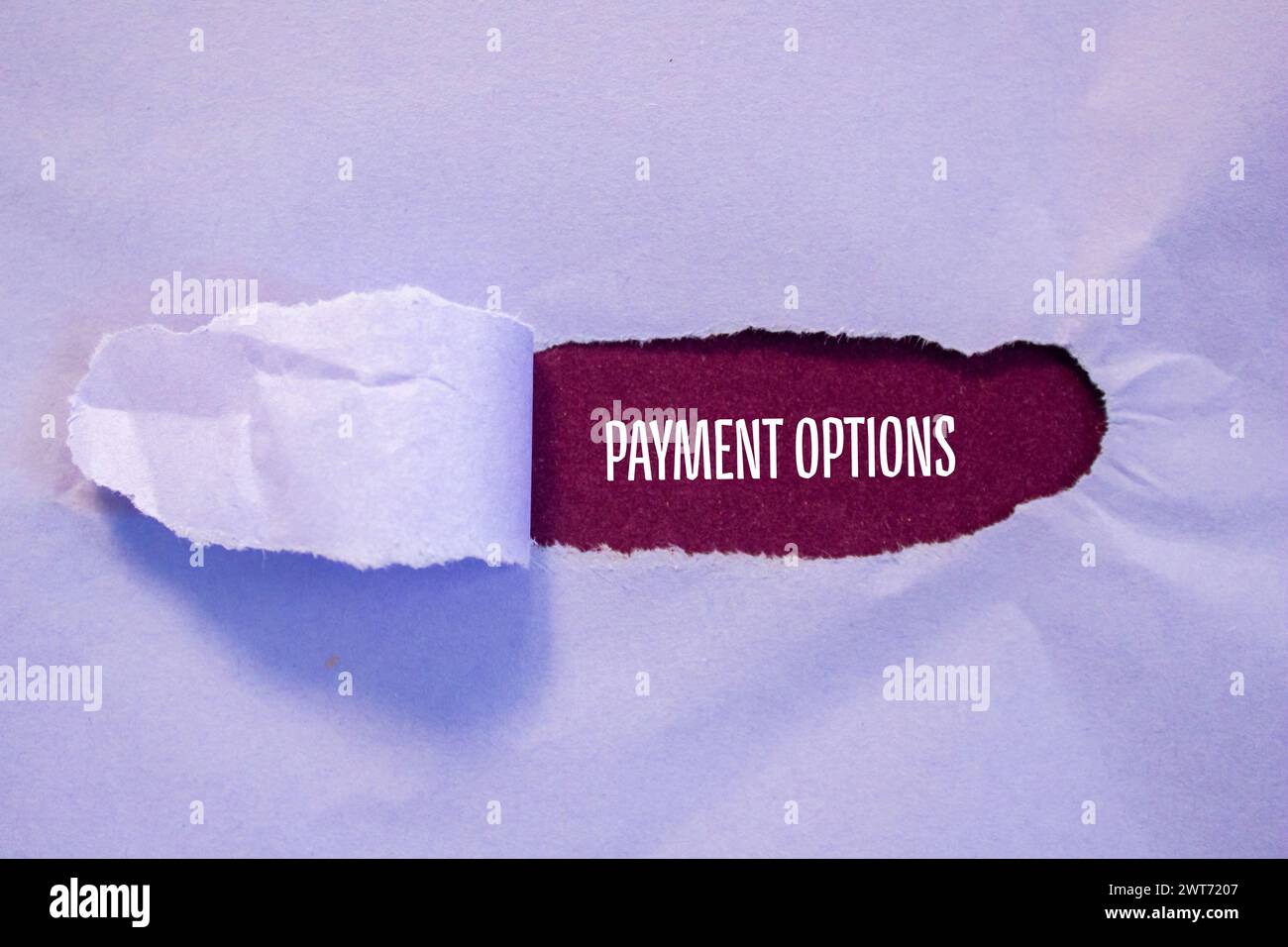 Payment options words written on purple torn paper with purple ...